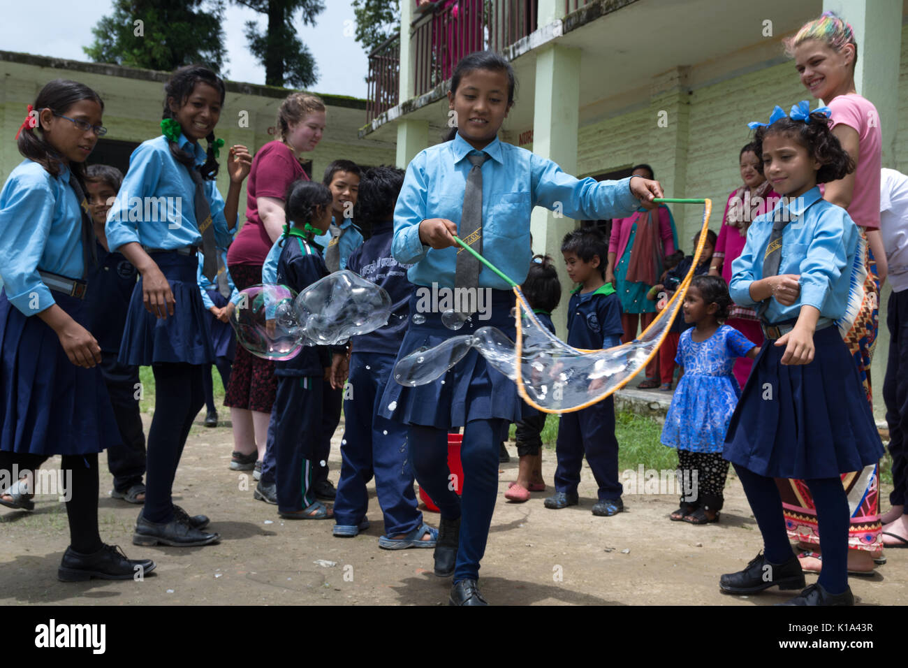 School children in the rural town of Dhulikhel enjoying a lesson from ...