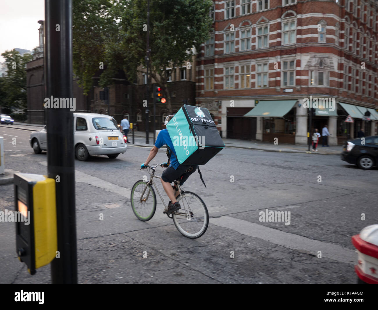 Deliveroo food delivery cycle courier City of London Stock Photo - Alamy