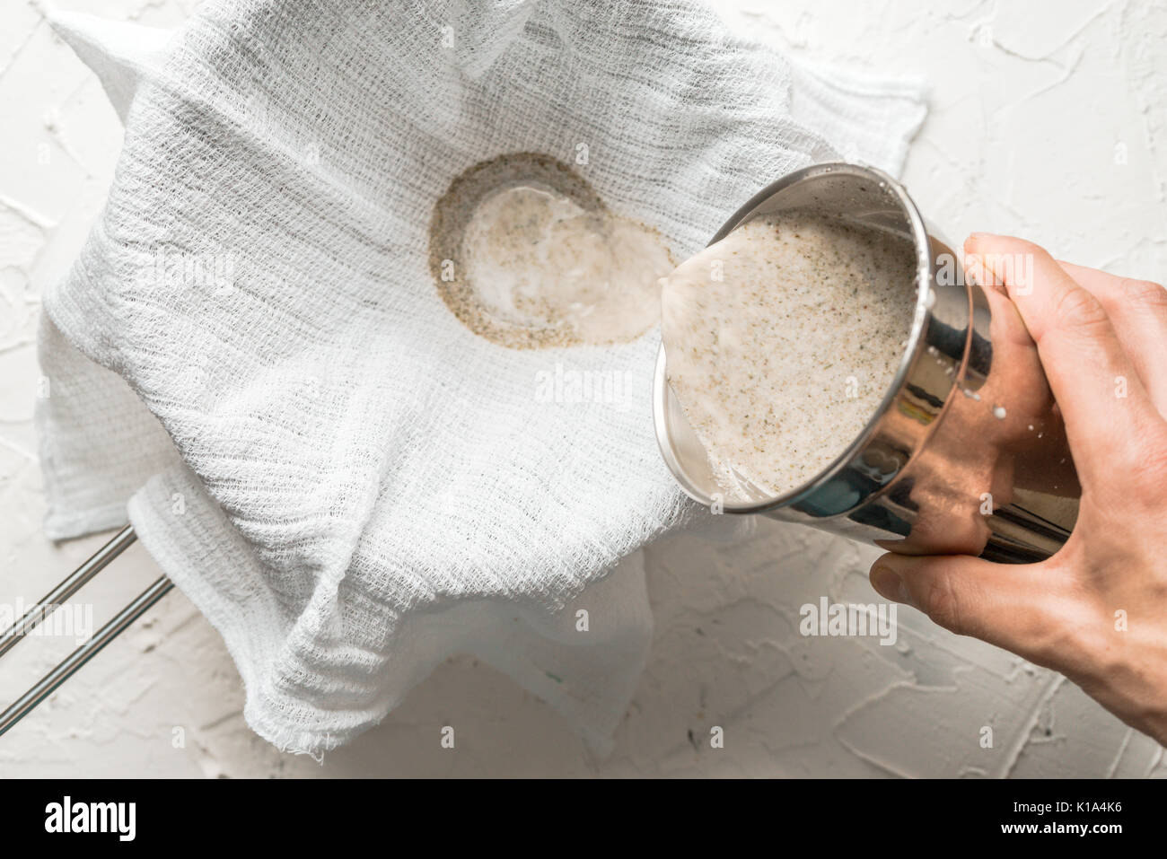 Strain the dense mass from hemp seeds through a napkin horizontal Stock ...