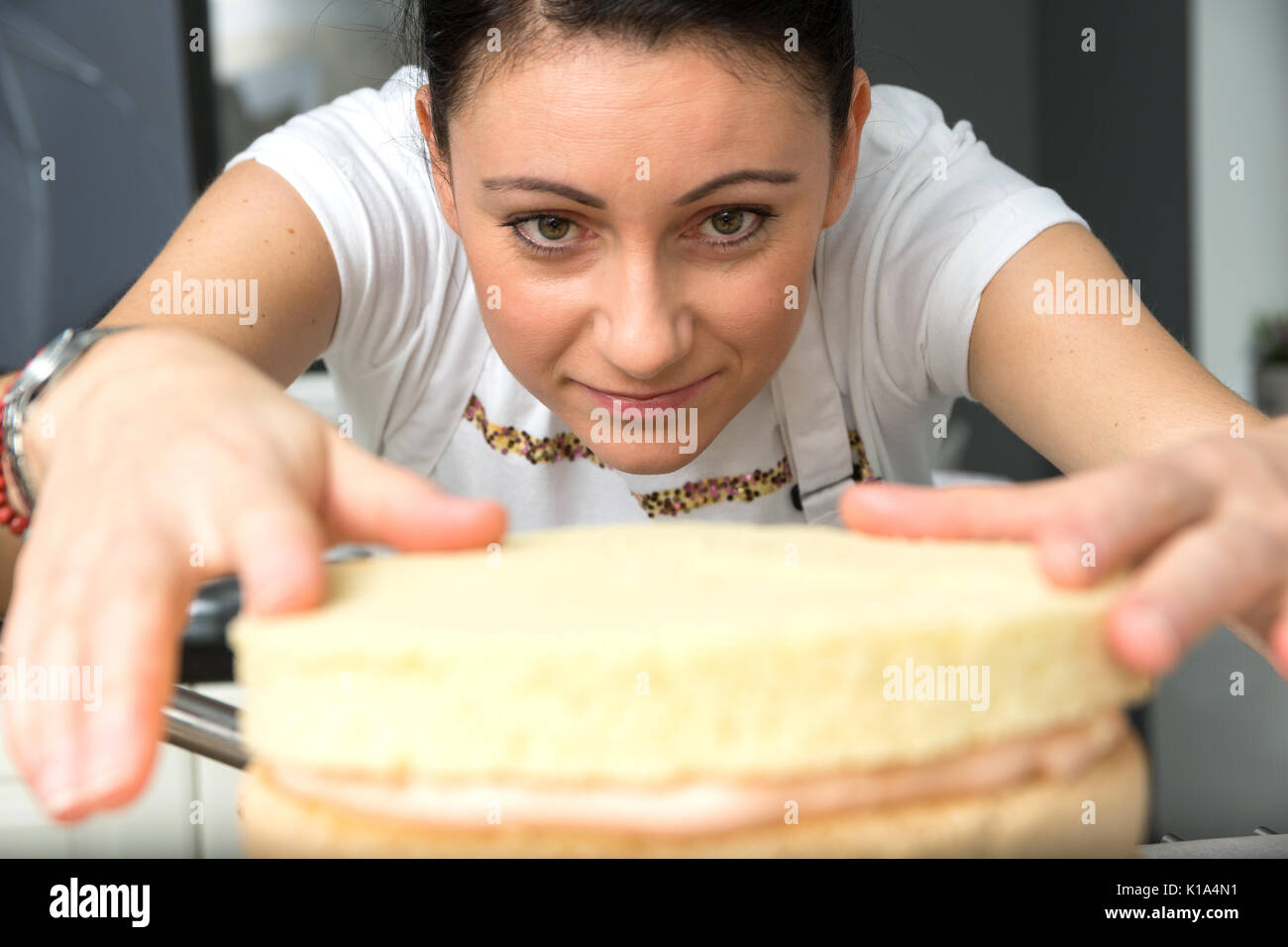 A woman baking a cake for an up coming birthday party Stock Photo - Alamy