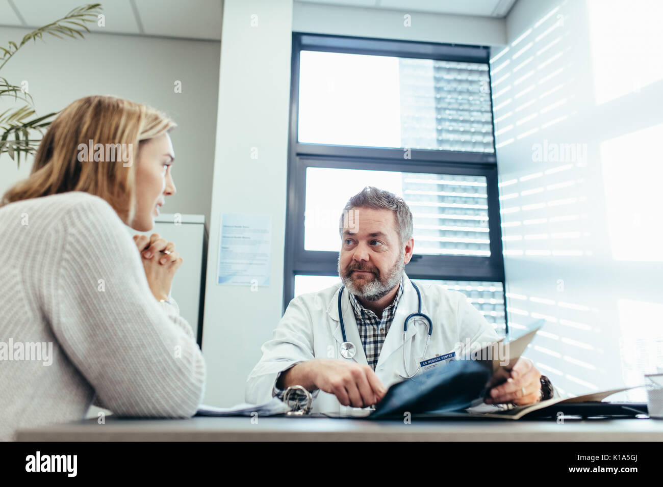 Male doctor having communication with patient. Medical specialist ...