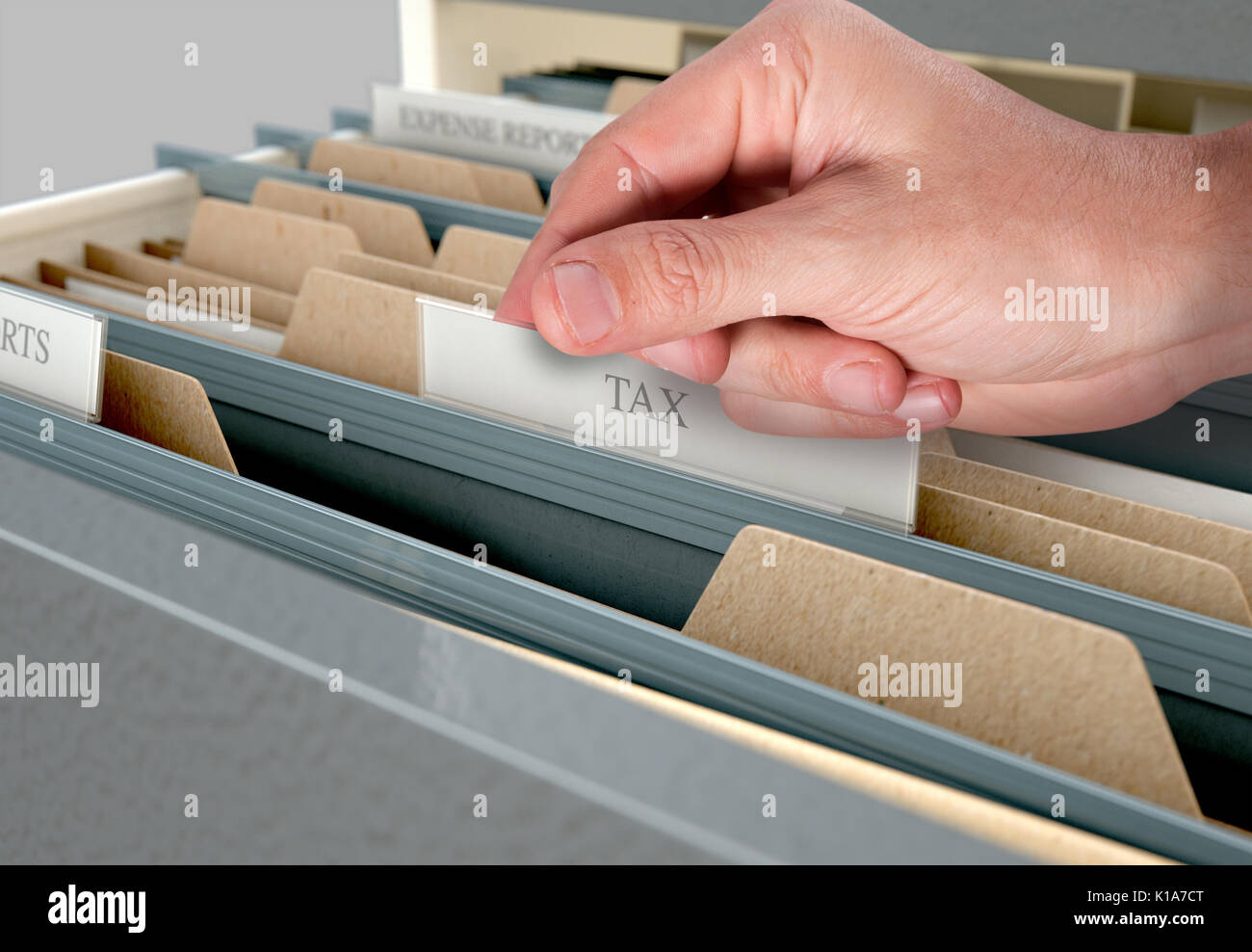 A male hand searching through documents in a filing cabinet drawer Stock Photo - Alamy