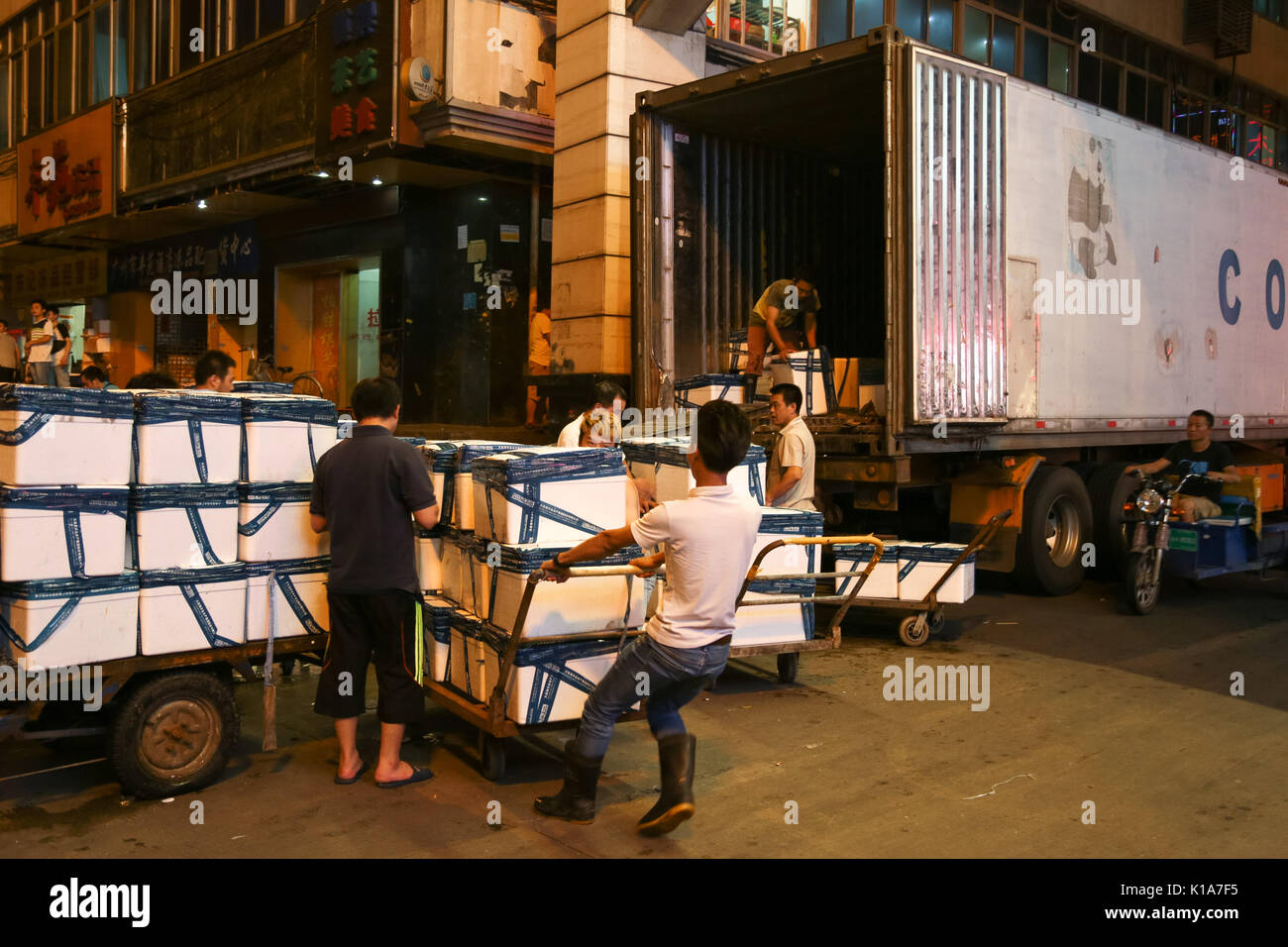 Workers unloading seafood cargos from a container trailer at Huangsha ...