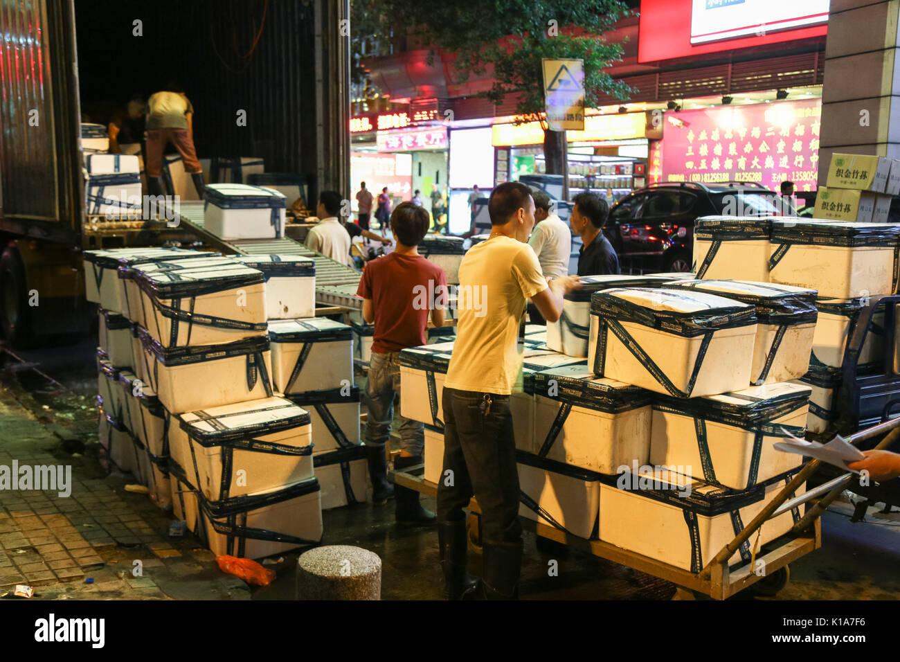 Workers unloading seafood cargos from a container trailer at Huangsha ...