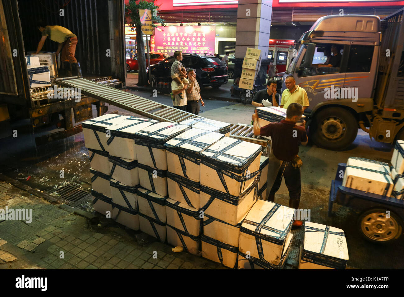 Workers unloading seafood cargos from a container trailer at Huangsha ...