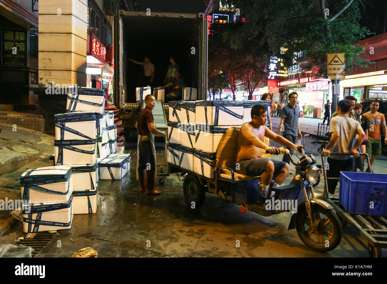 Workers unloading seafood cargos from a container trailer at Huangsha ...