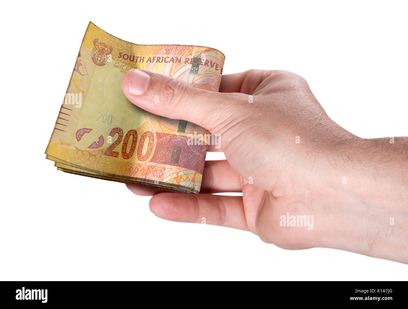 A male hand handing over a wad of folded south african rand bank notes ...