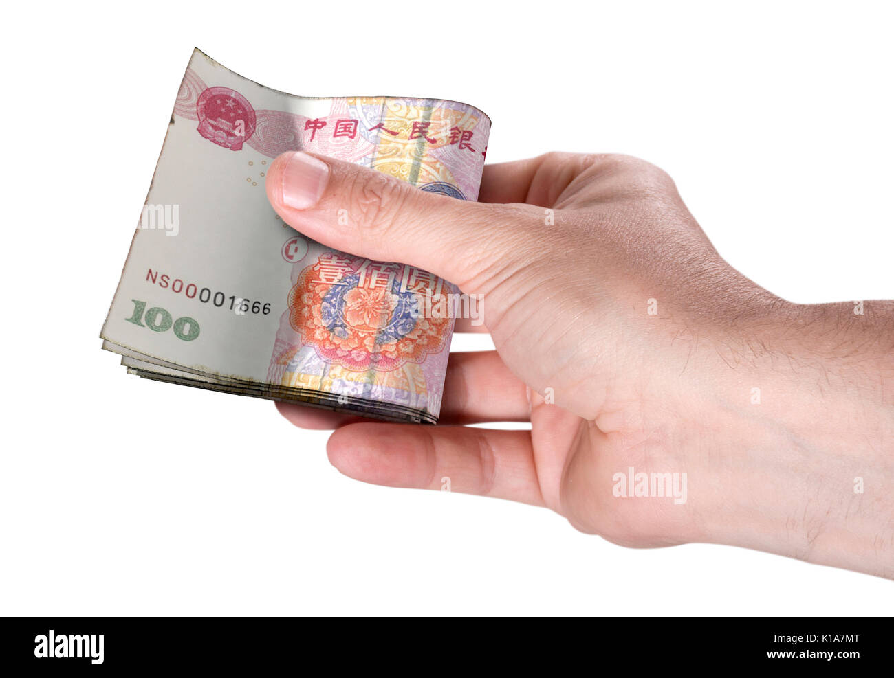A male hand handing over a wad of chinese yuan folded bank notes on an ...