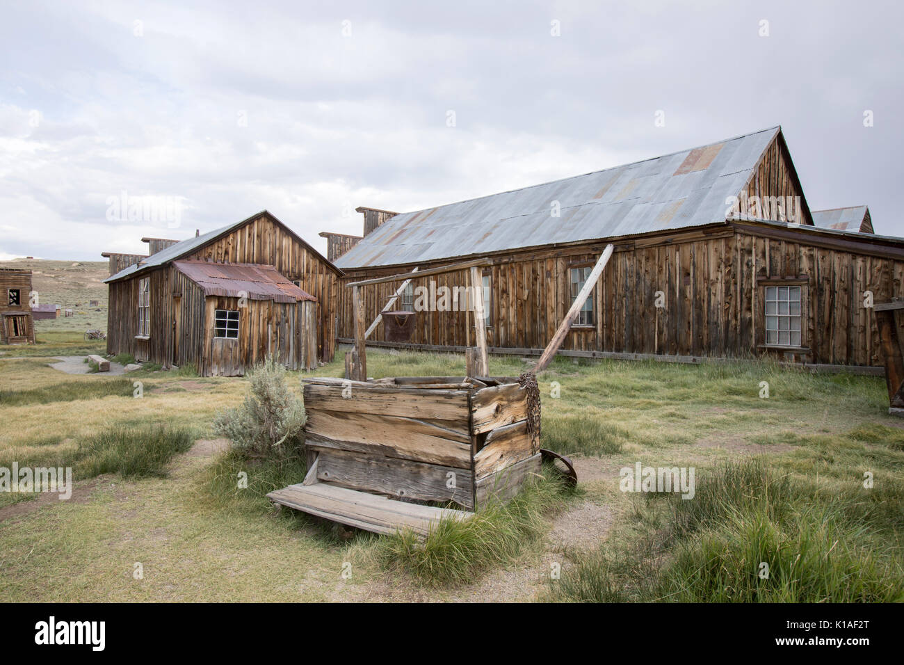 Wooden water well outside rustic barn in Bodie State Historic Park ...