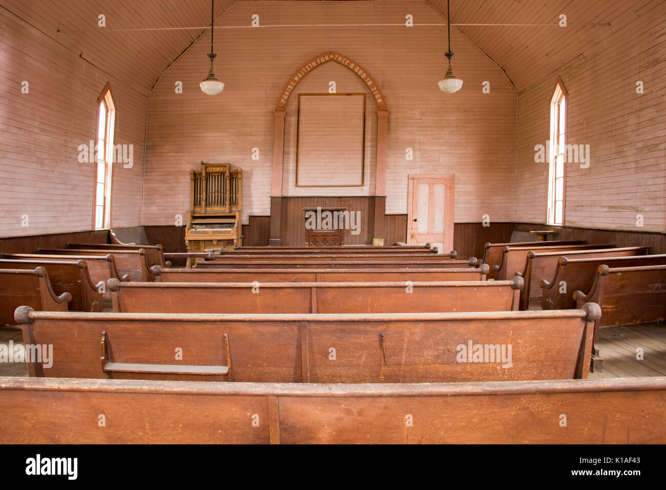 Wooden pews inside rustic Methodist church in Bodie State Historic Park ...
