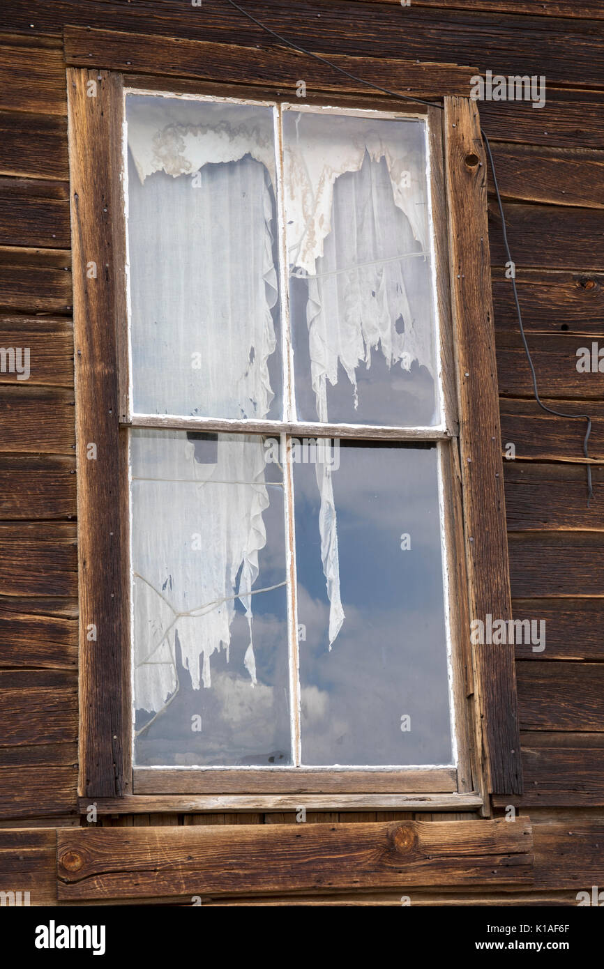 Tattered curtain in window of rustic wooden house Stock Photo - Alamy