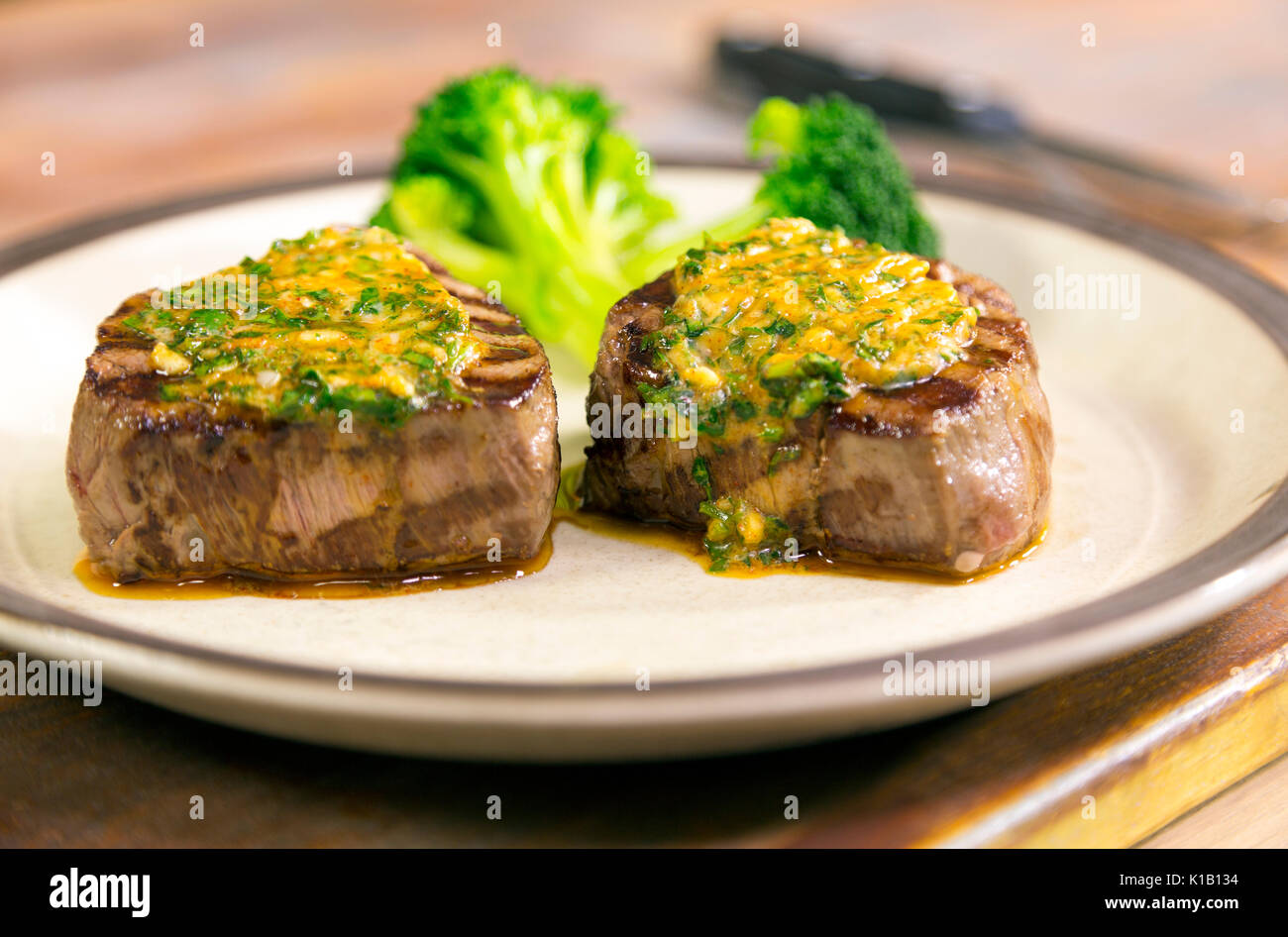 Delicious grilled beef plate served with melted butter and brocllies in ...
