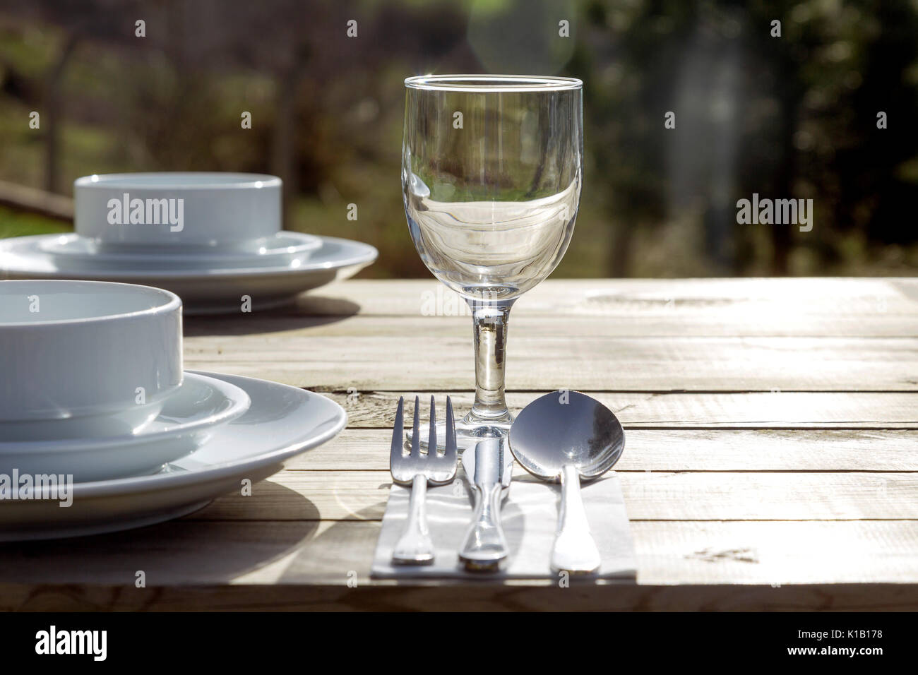 Outdoor wooden dining table is ready for service in garden Stock Photo ...