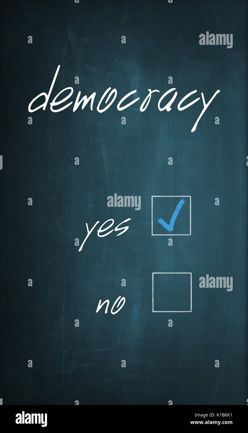 Conceptual text "Democracy" written with chalk on a dirty blackboard ...