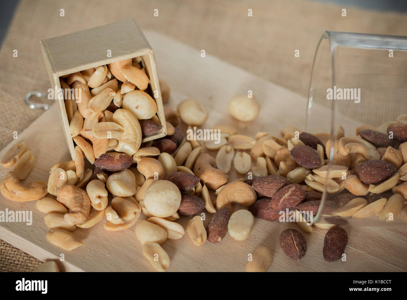 fresh roasted cocktail nuts (many type of nuts) on wooden plate Stock ...