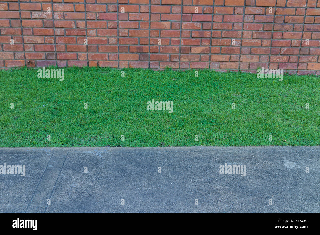 Old Red brick wall and green grass Stock Photo - Alamy