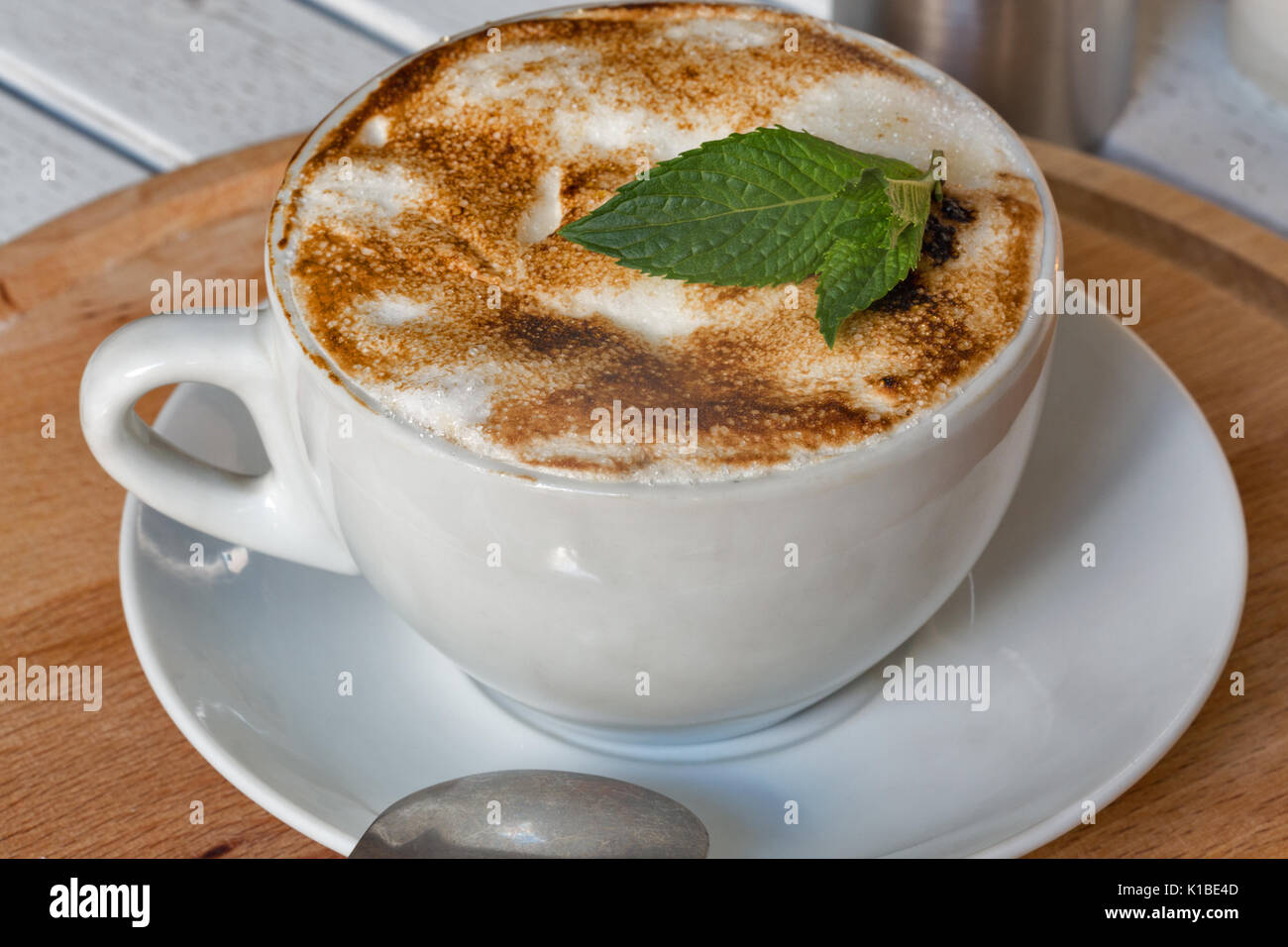 Coffee cup on white bar table closeup Stock Photo - Alamy