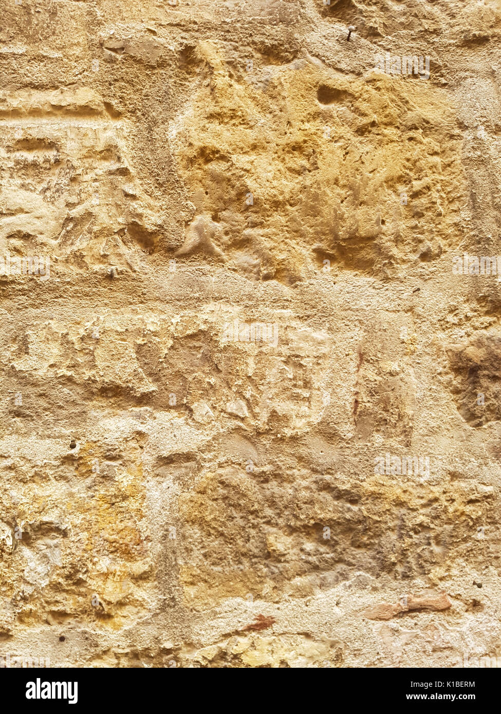 Detail of the old yellow stone wall Stock Photo - Alamy
