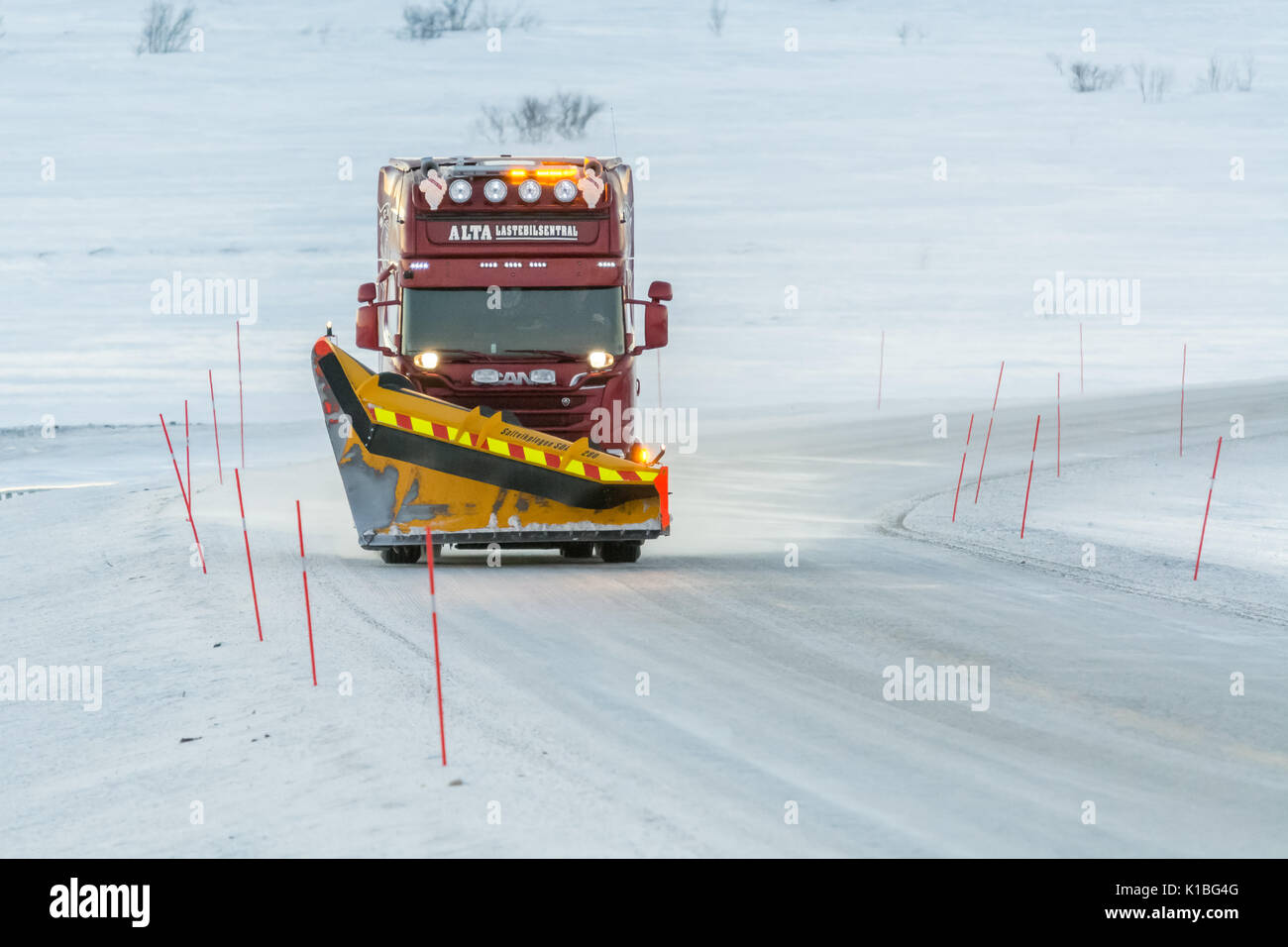 Truck with snow plough on the road, icy winter road in Finnmark Stock ...