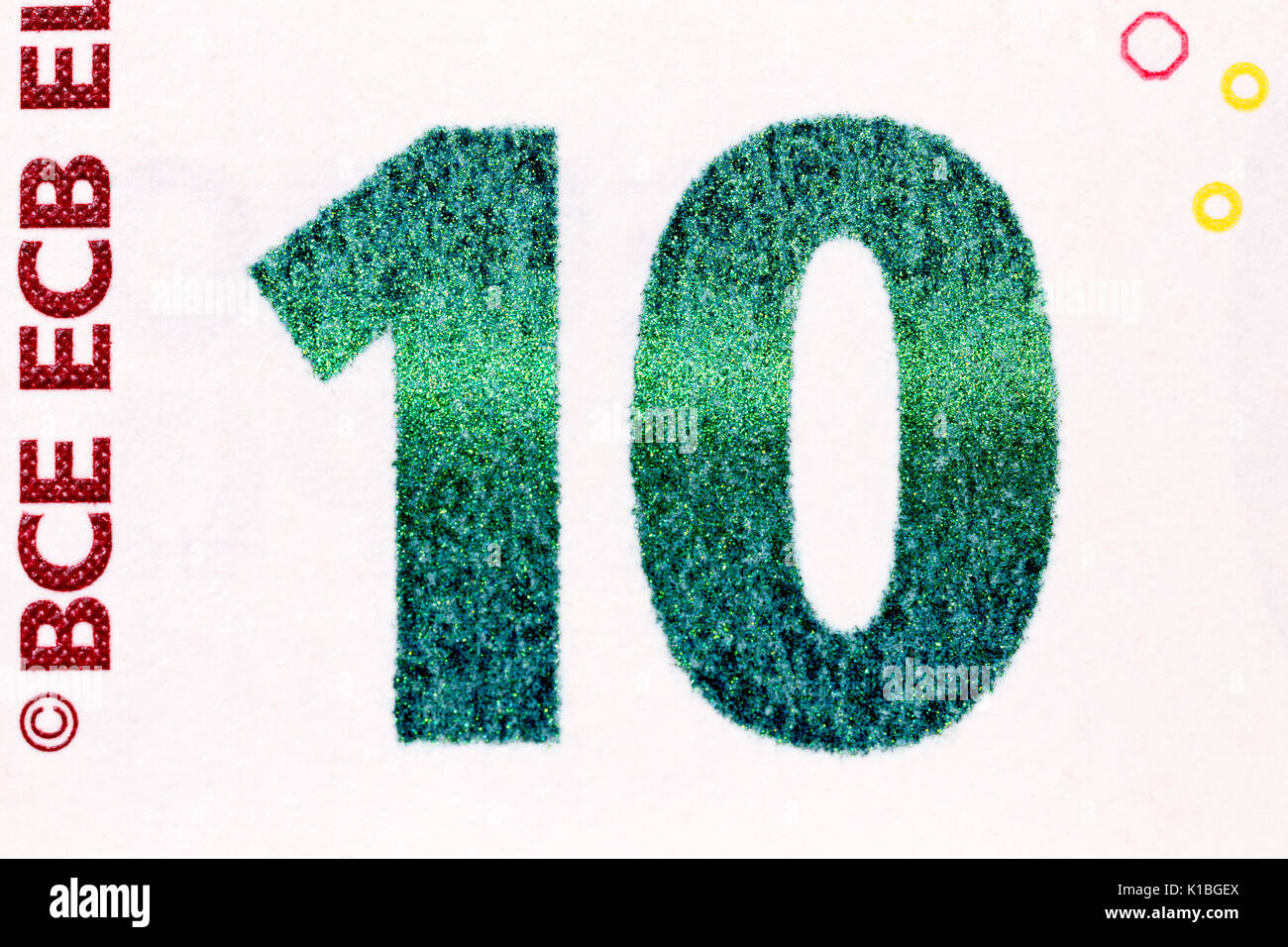 Macro shot of a ten euro bill showing the number ten with its texture ...