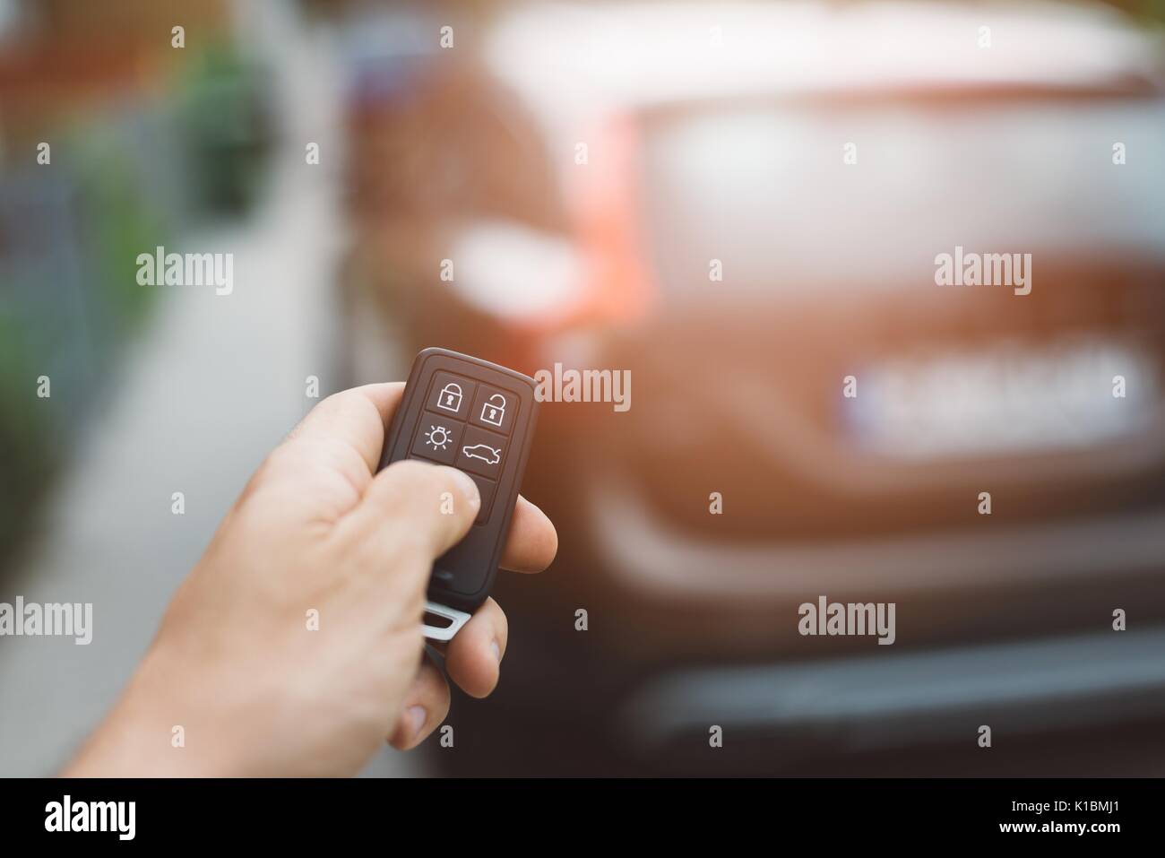 Man opening or closing car with remote control Stock Photo - Alamy