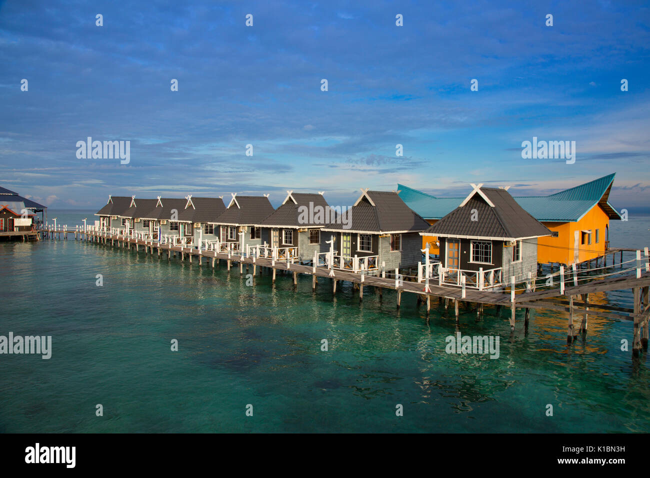 Tourist bungalows over the ocean at Billabong Dive Resort, Mabul Island ...