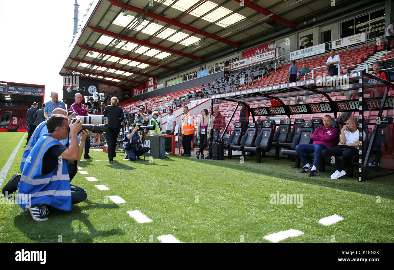 Manchester City manager Pep Guardiola (right) speaks to assistant ...