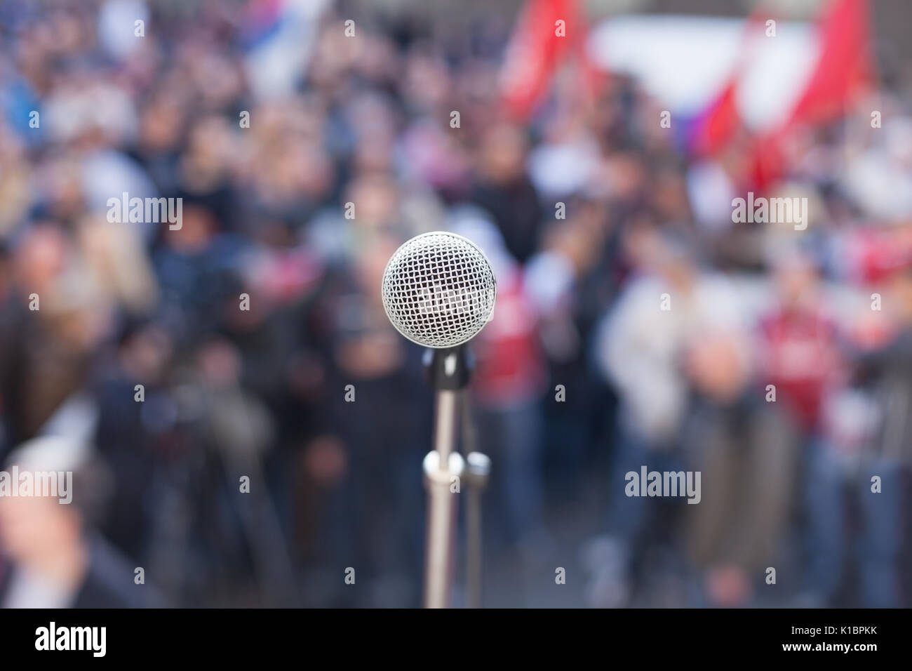 Microphone in focus against blurred crowd Stock Photo - Alamy