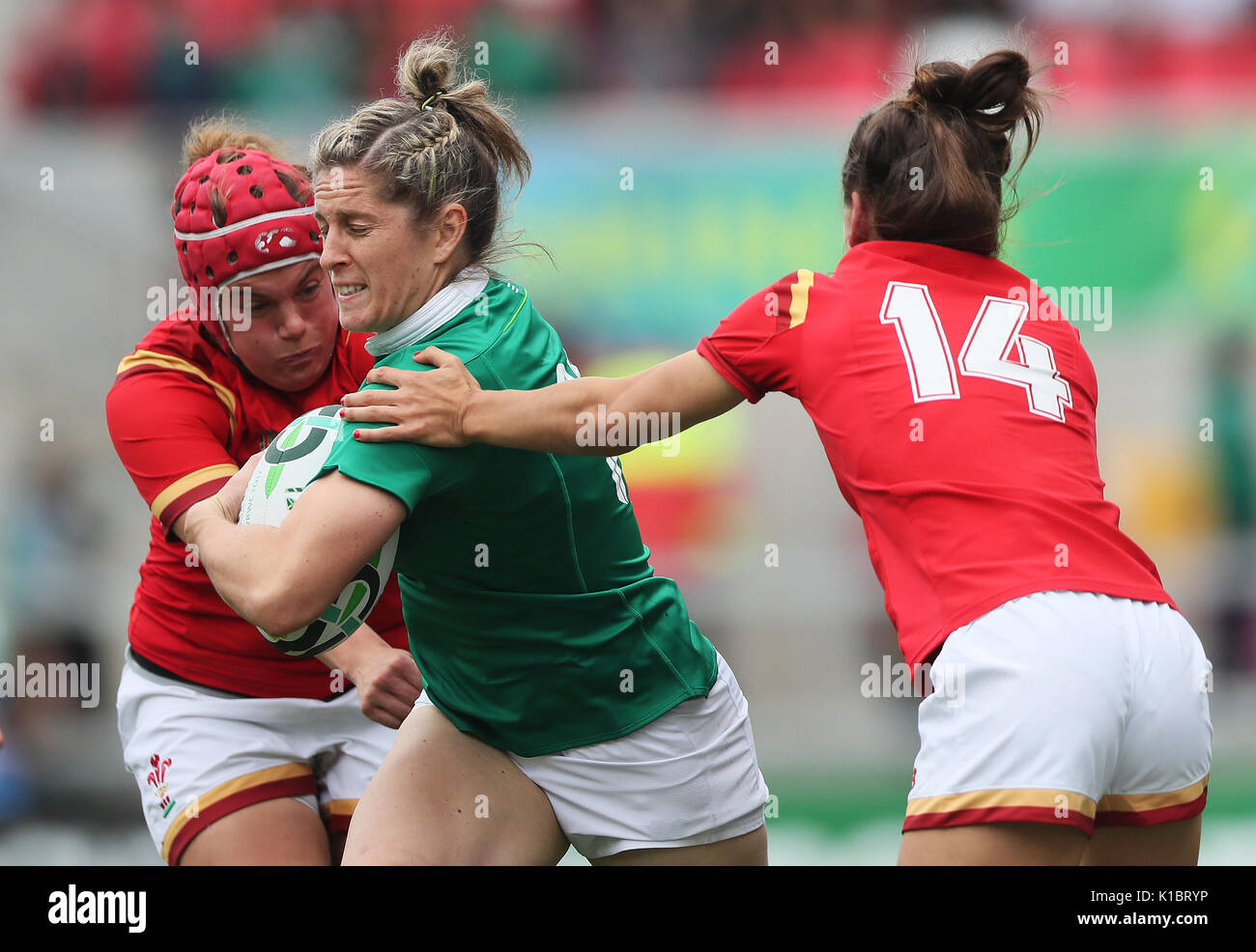 Ireland's Alison Miller is tackled by Wales' Carys Phillips (left) and ...