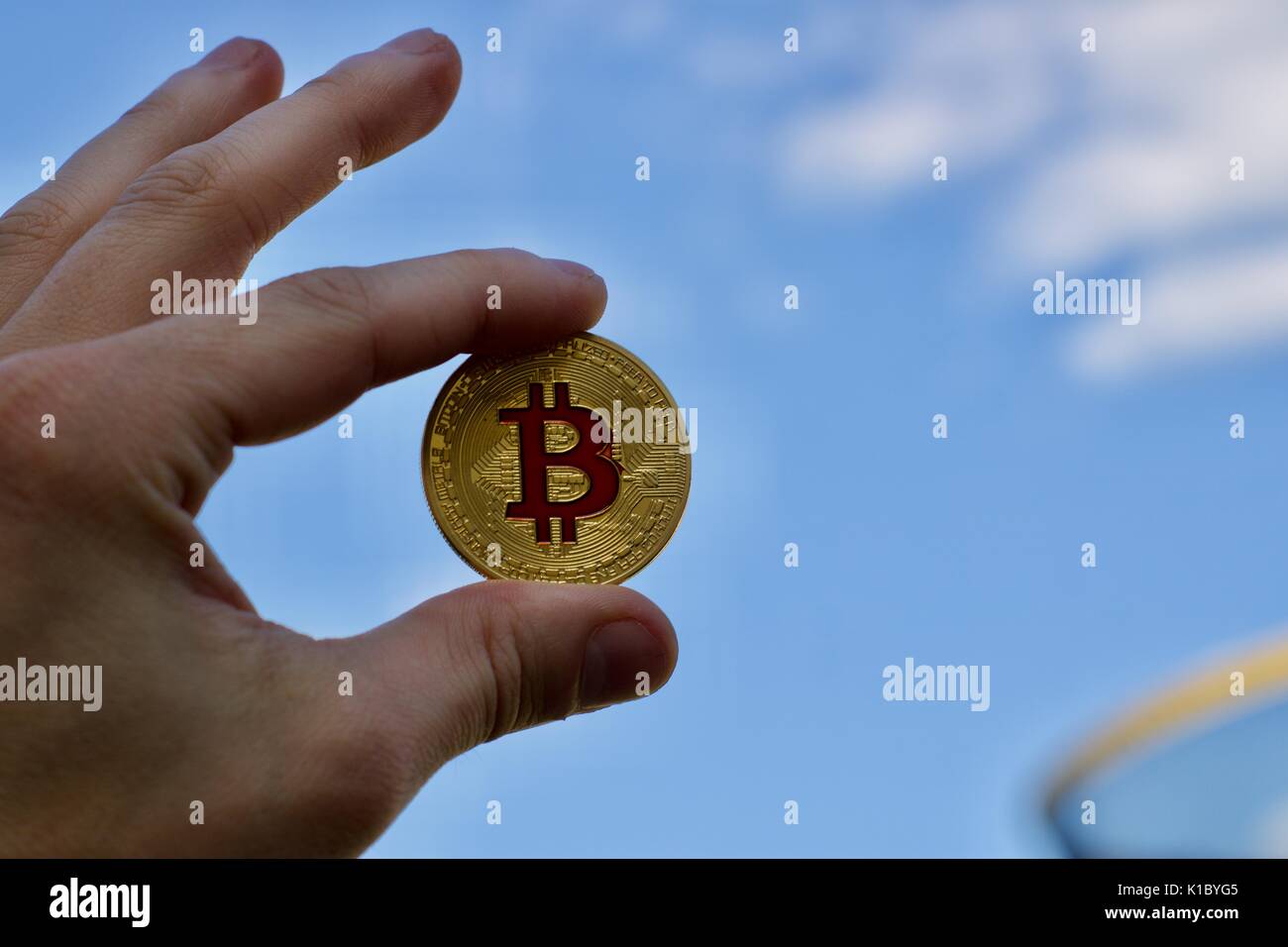 Digital currency physical gold red bitcoin coin. Outdoor money concept ...