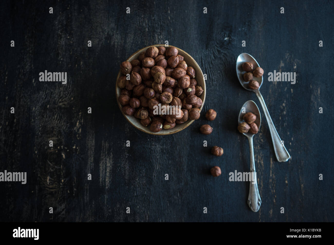 Organic nuts on dark wooden table with copyspace Stock Photo - Alamy