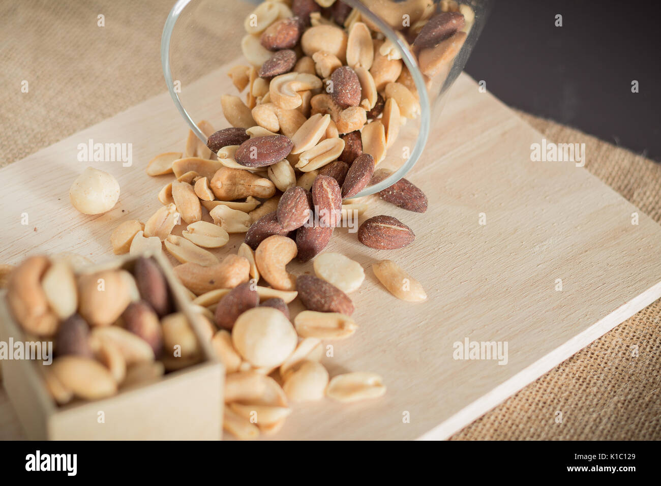 fresh roasted cocktail nuts (many type of nuts) on wooden plate Stock ...
