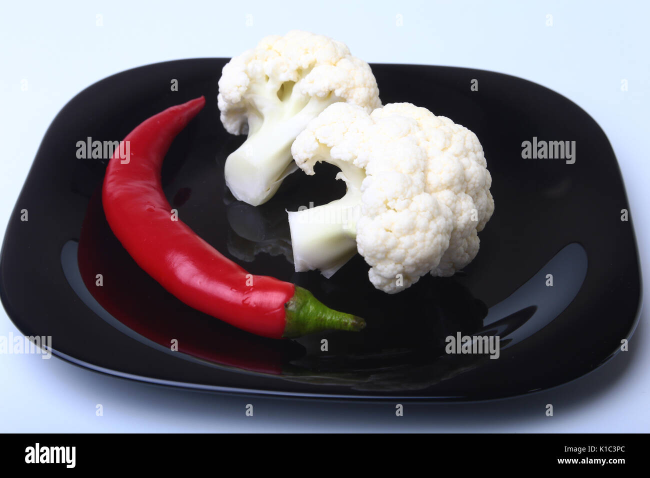 fresh cauliflower on black plate. Ready for cooking Stock Photo - Alamy