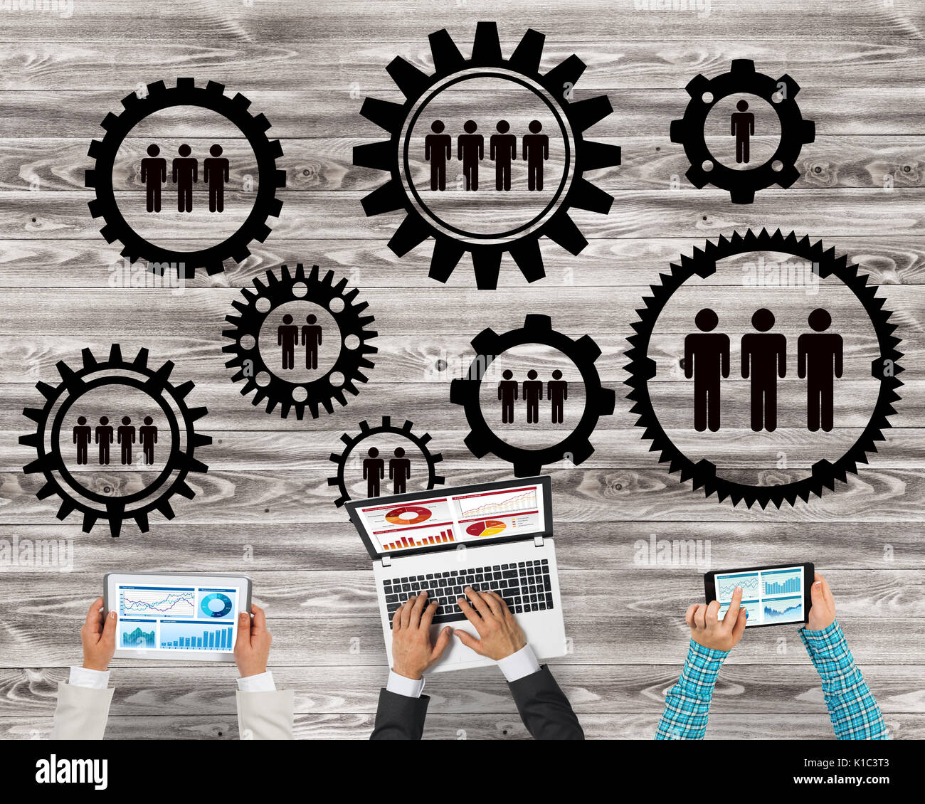 Group of three people with devices in hands working together as symbol ...