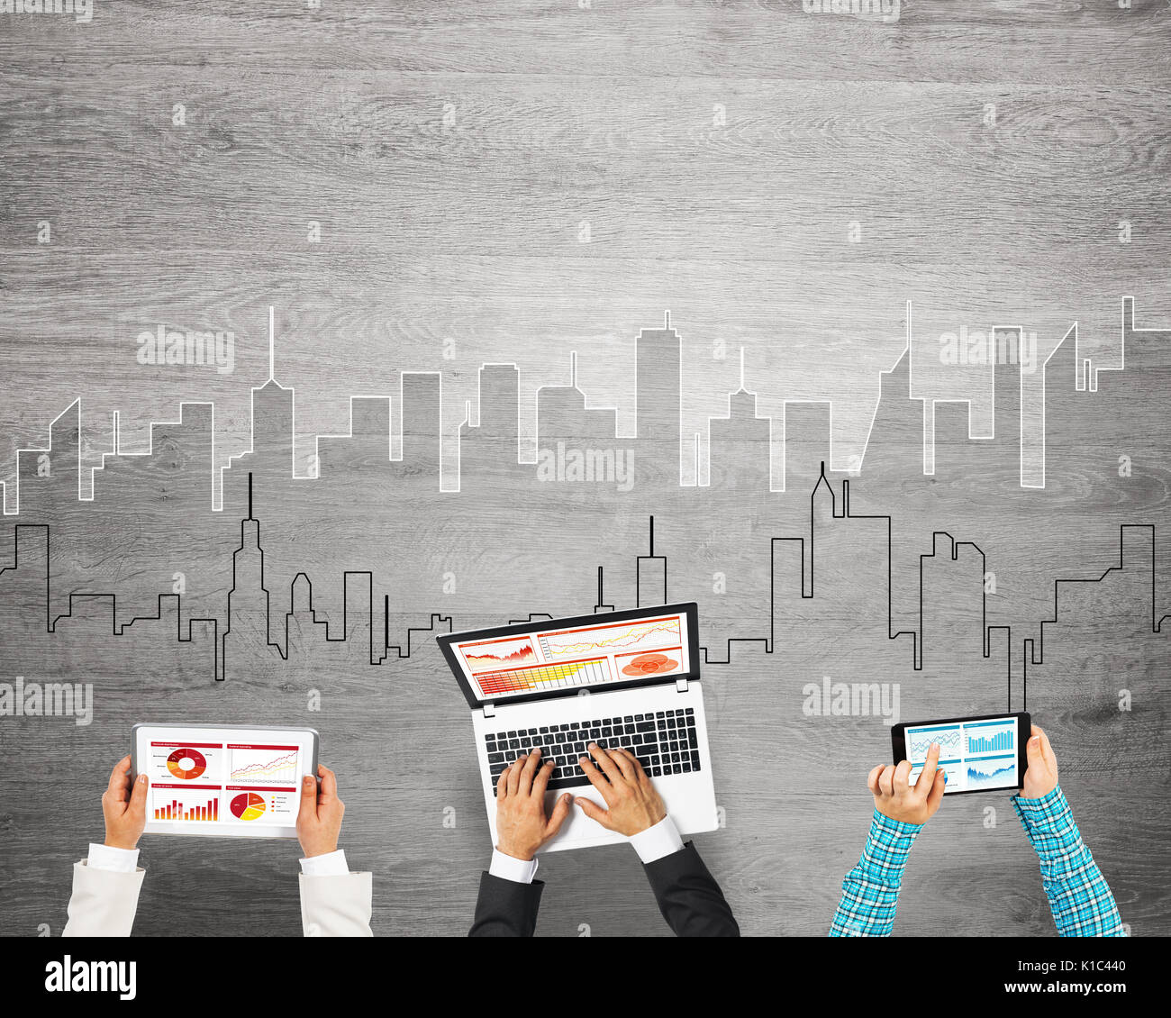 Group of three people with devices in hands working together as symbol ...