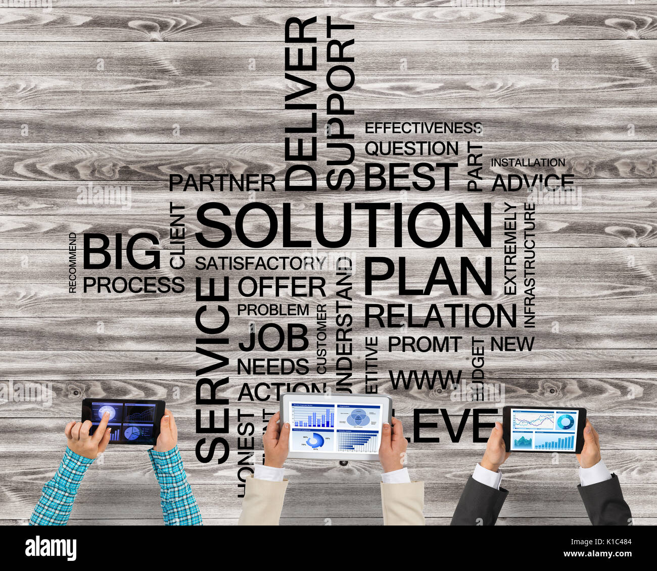 Group of three people with devices in hands working together as symbol ...