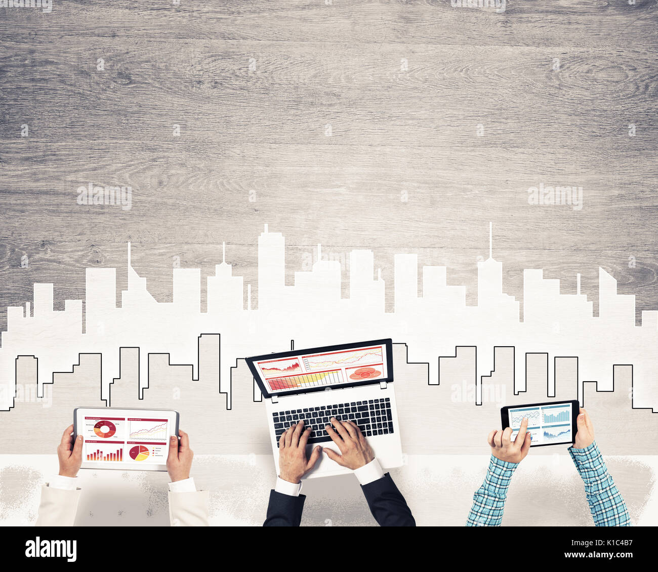 Group of three people with devices in hands working together as symbol ...
