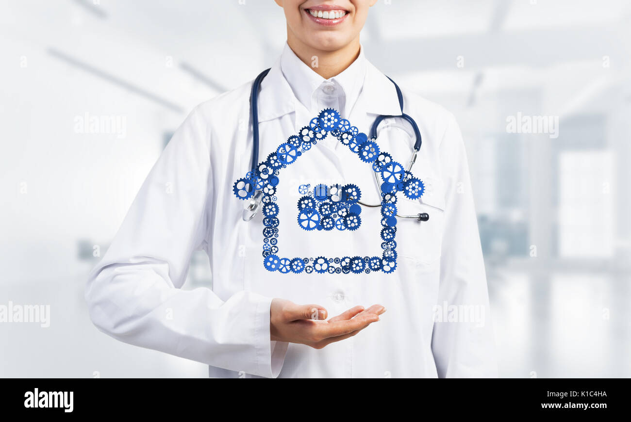 Hand of woman doctor showing house or home gear sign in palm Stock ...