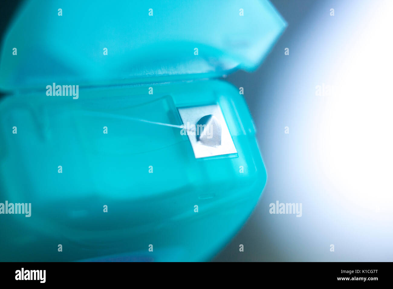Dental floss tape closeup on plain background Stock Photo - Alamy