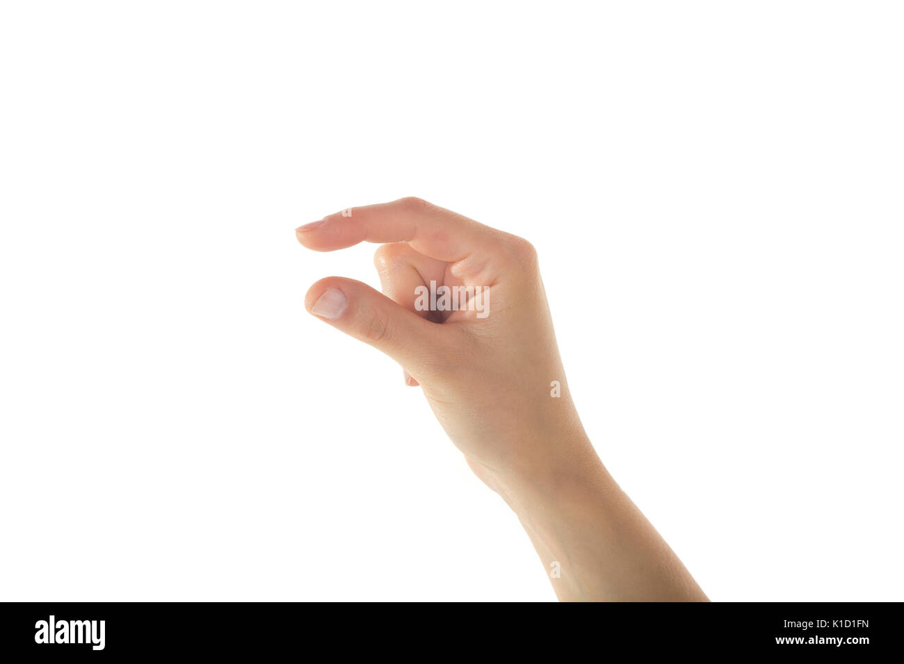 A gentle female hand is holding something gently with her right hand on ...