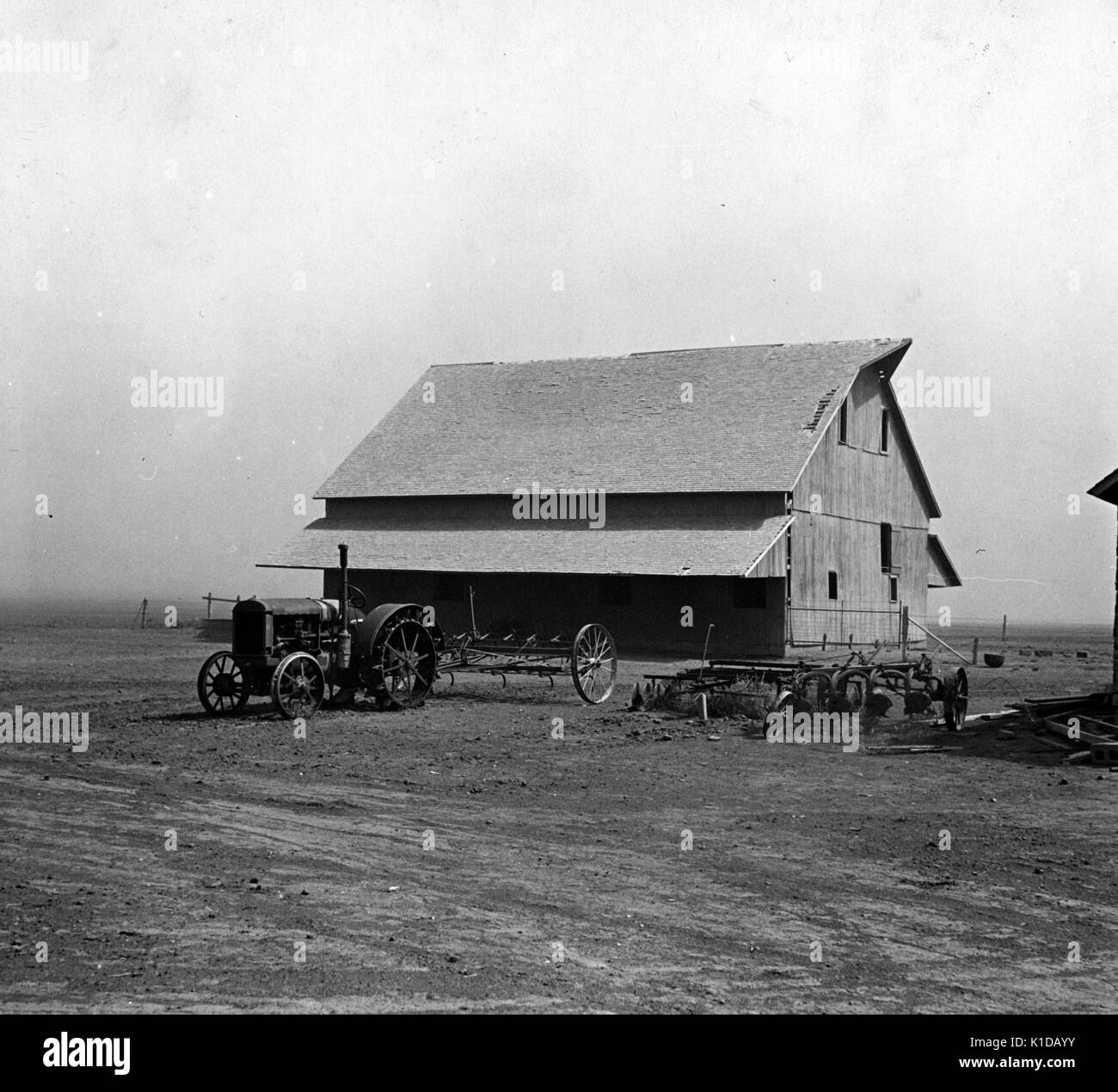 Barn on a farm in Kansas during the dustbowl era, surrounding by bleak ...