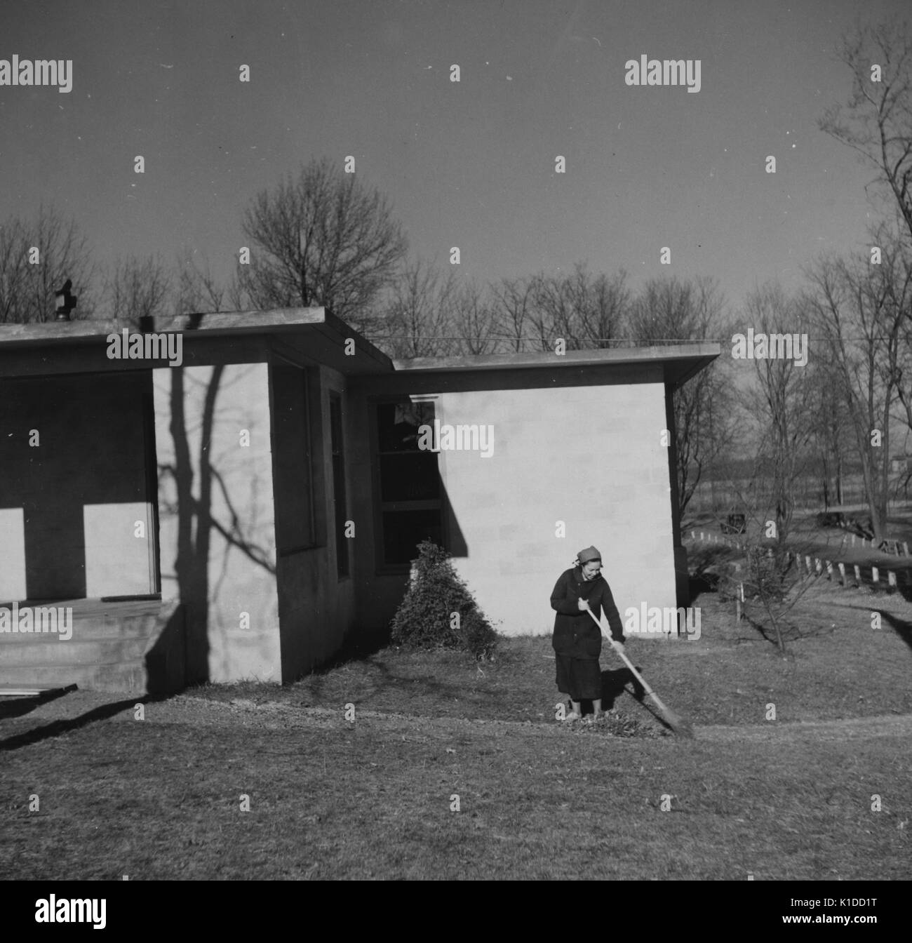Woman sweeping a path outside a home in Hightstown, New Jersey, 1936 ...