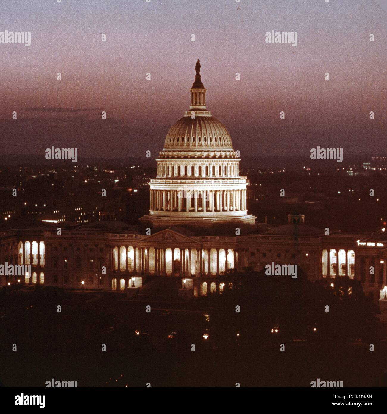 A long distance front view of the United States Capitol, lighted up ...
