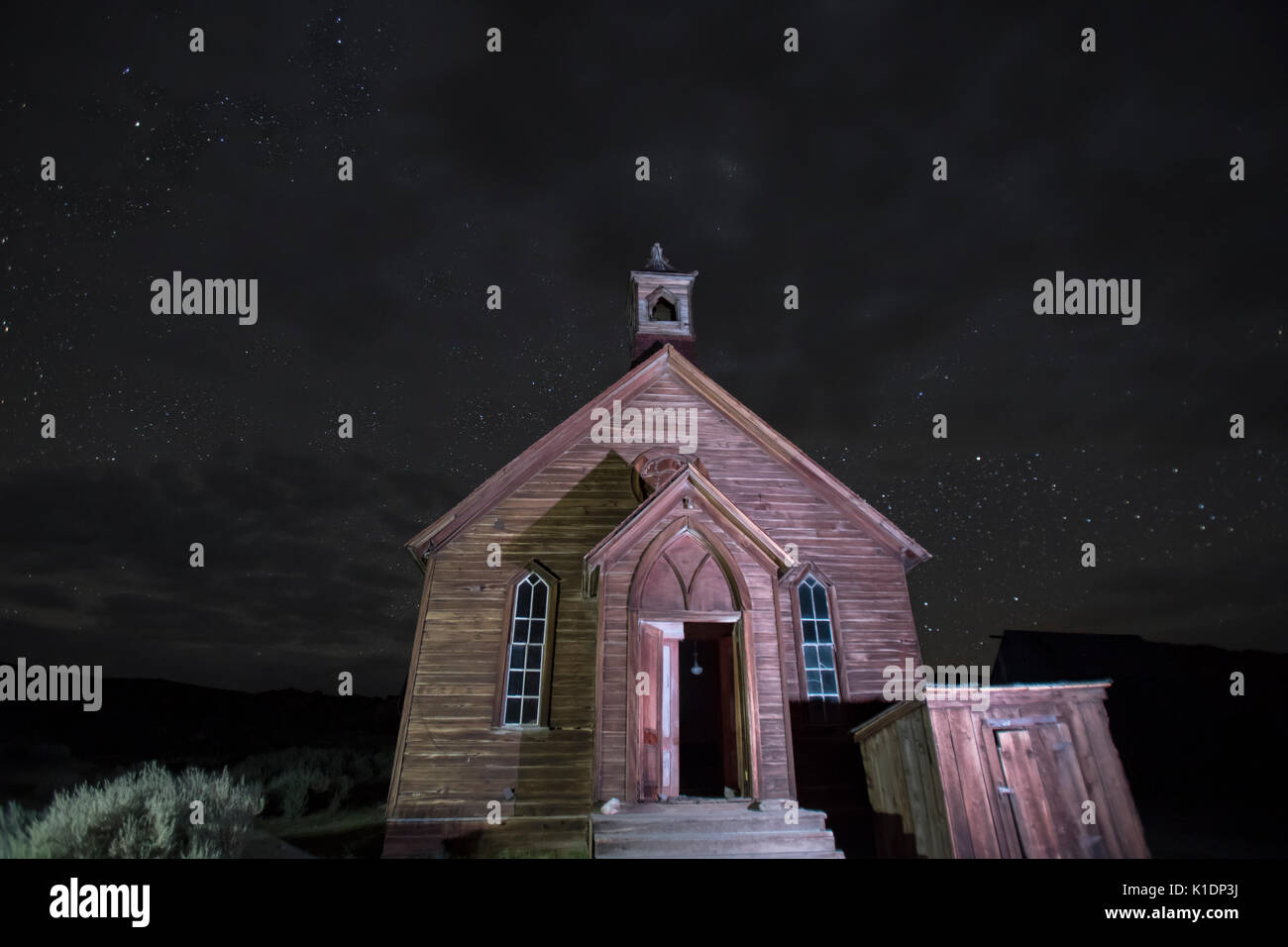 Methodist church illuminated against night skies in Bodie State ...