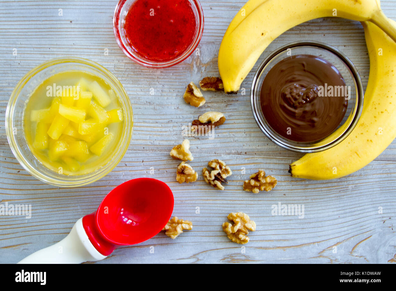Deconstructed banana split ingredients on rustic wood Stock Photo - Alamy