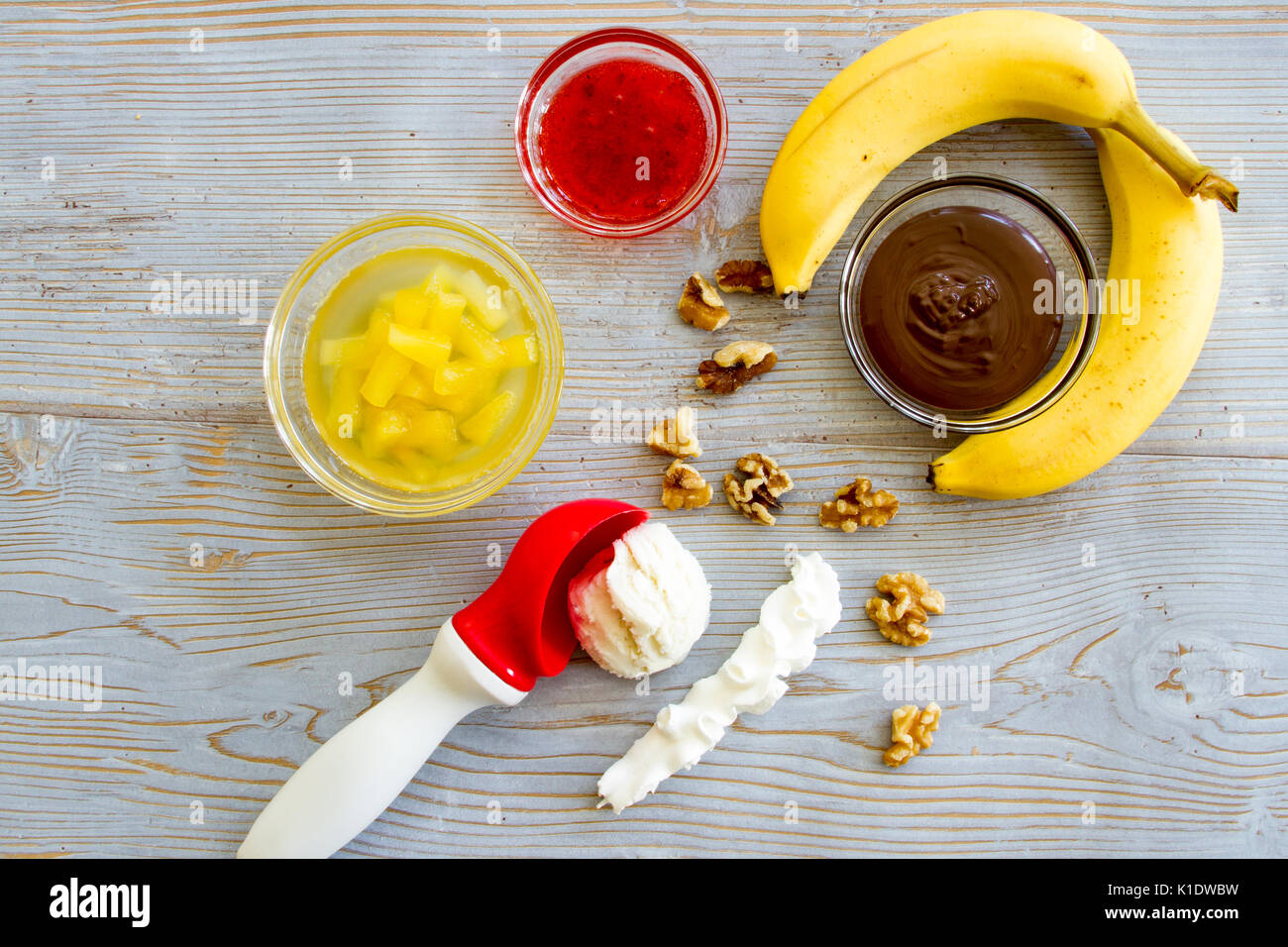 Deconstructed banana split ingredients on rustic wood Stock Photo - Alamy