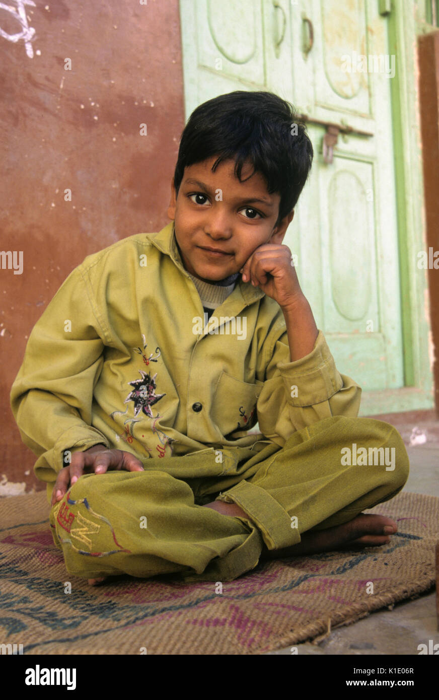 Young boy sitting outside his home, Udaipur, Rajasthan, India Stock ...