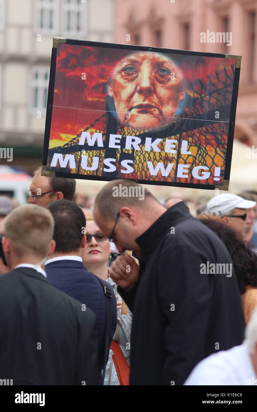 Quedlinburg, Germany. 26th Aug, 2017. Demonstrators hold up a sign ...