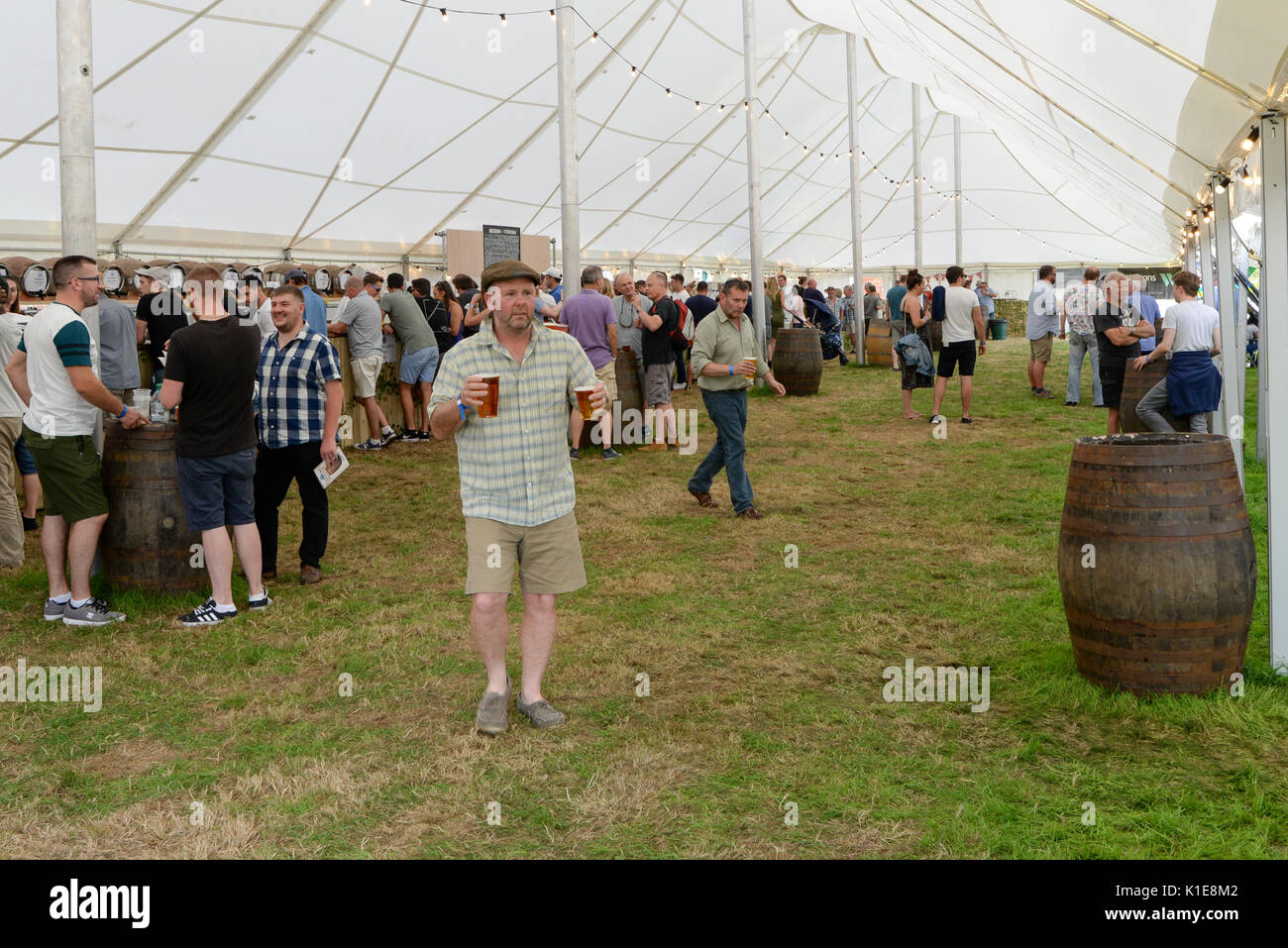 Man carrying pints of beer at a beer festival Stock Photo - Alamy