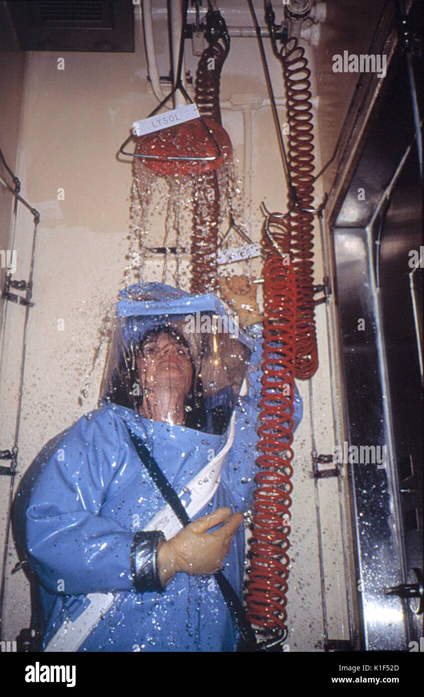 A CDC scientist showers in a protective suite before leaving a ...